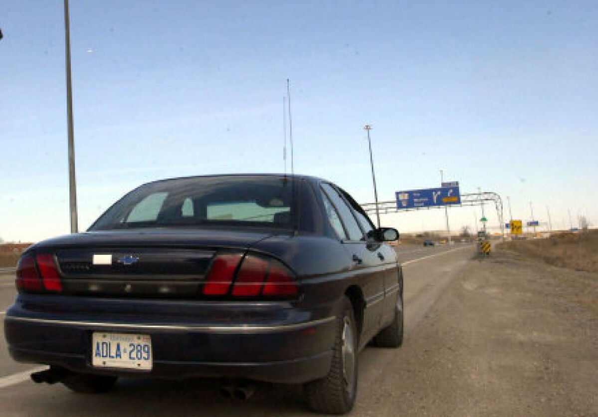 Is that unmarked car signaling you to stop really a cop?