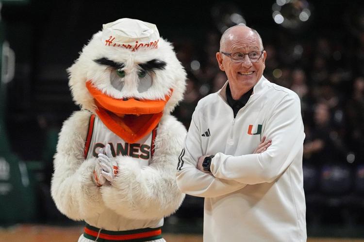 Miami unfurls a banner to honor retired coach Jim Larrañaga, who led ...