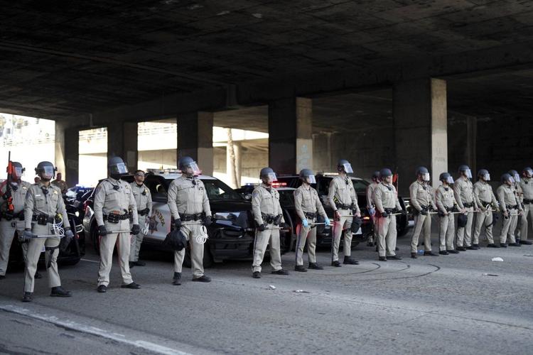Marchers protesting planned deportations block major freeway in Los Angeles