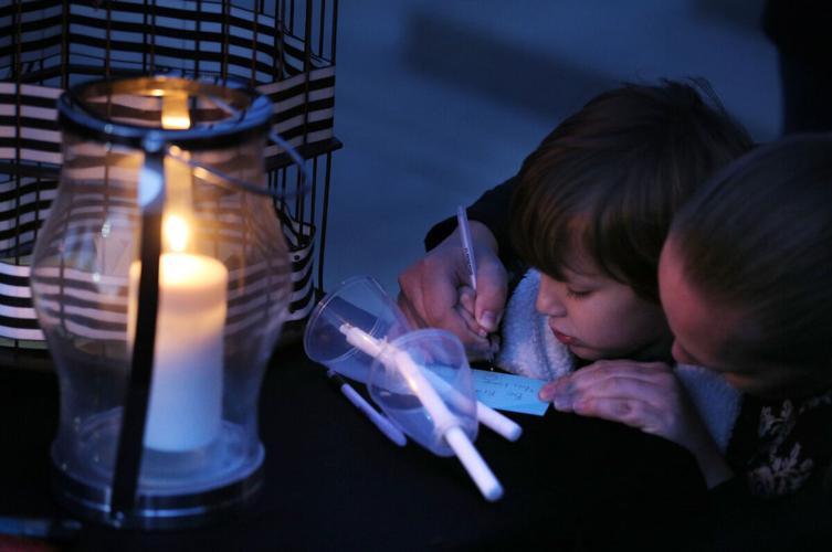 Hundreds gather in vigil to remember Neville-Lake family