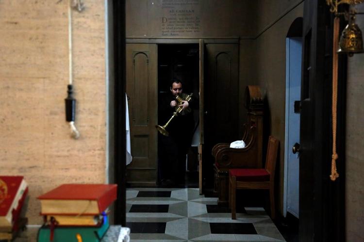 Young priest loses mentor, then his father -- both to virus