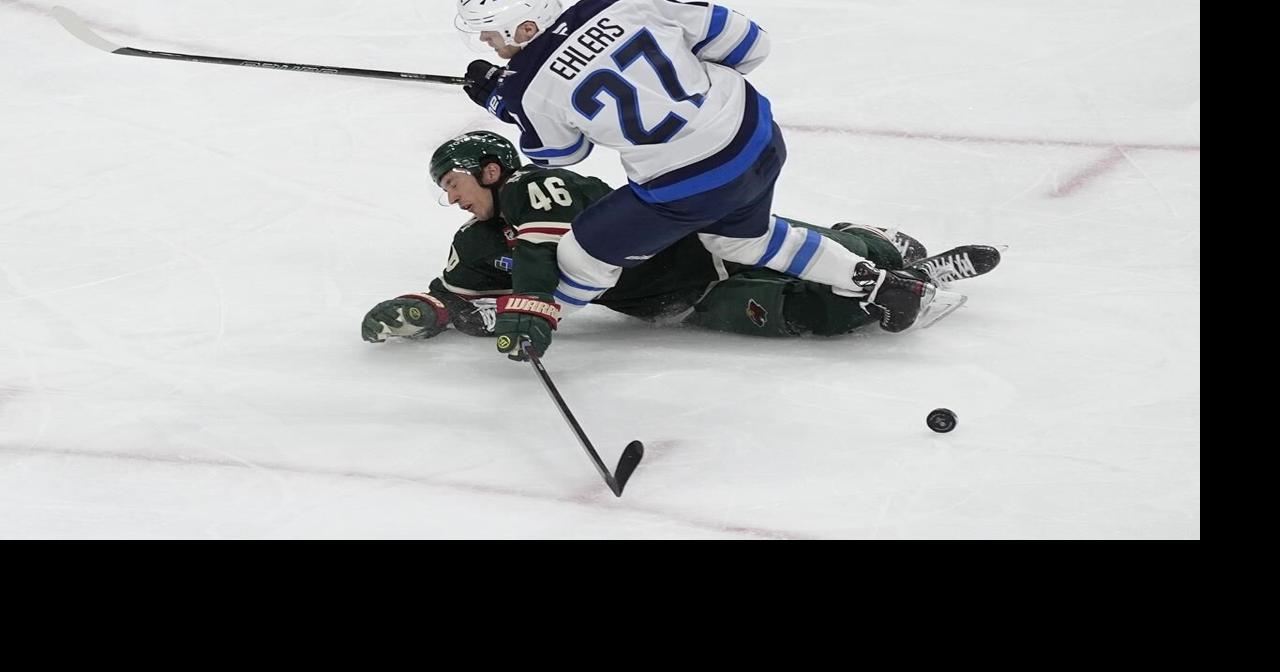 Jets forward Nikolaj Ehlers departs after colliding with an official in the second period