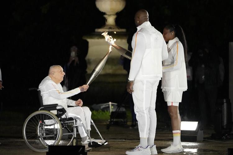 Olympic cauldron is lit by French gold medalists Teddy Riner and Marie ...
