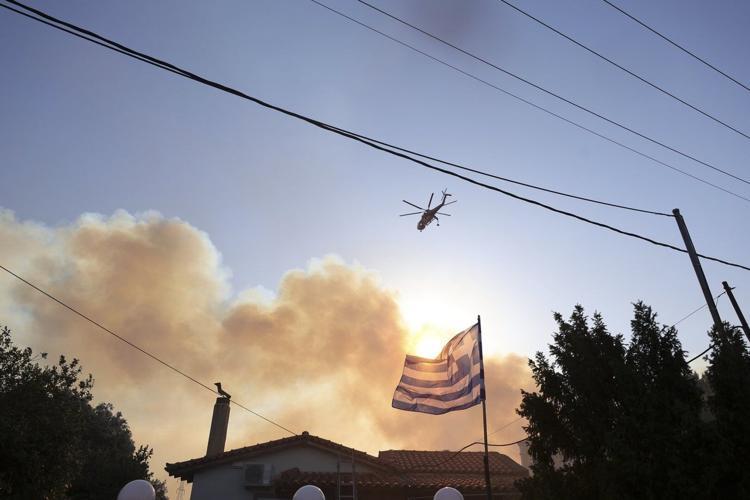 Photos of a wildfire near Athens as homes burn