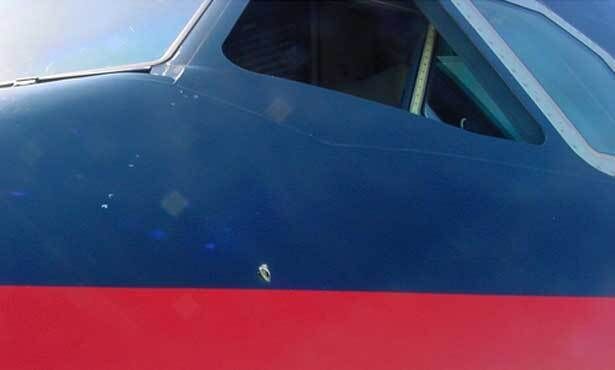 Armed pilot shoots hole in airliner