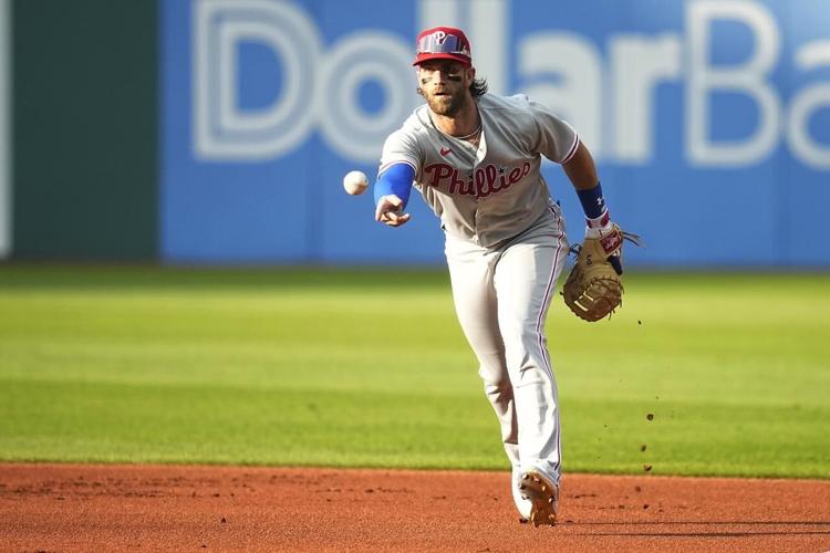 Phillies star Bryce Harper makes catch tumbling into photo pit in first ...