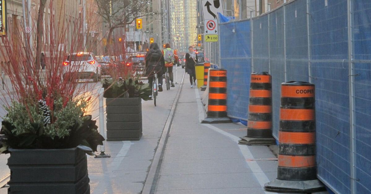 Cyclists and pedestrians mingle in temporary bike lane