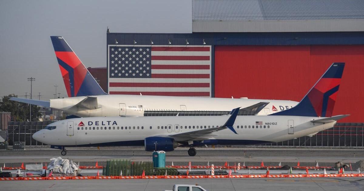 Man dies after climbing into Delta jet engine