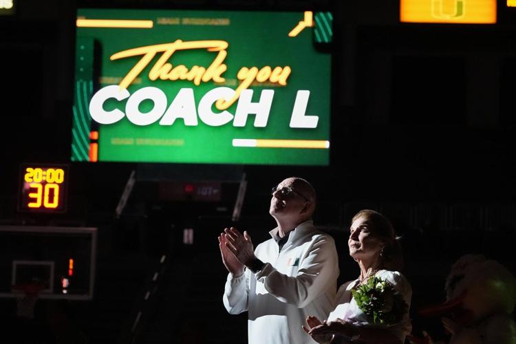 Miami unfurls a banner to honor retired coach Jim Larrañaga, who led ...