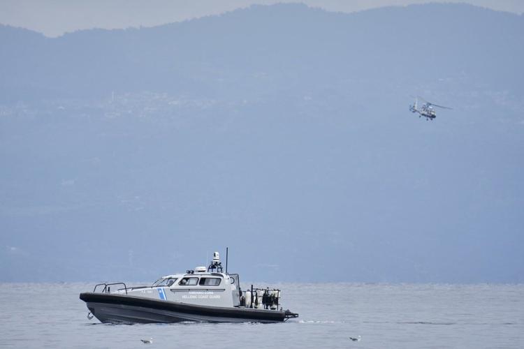 Rescuers search for a girl missing after a migrant boat sank near Greek ...