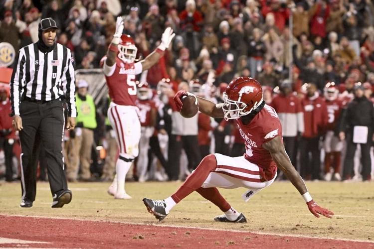 Arkansas rockets past No. 14 Ole Miss behind Sanders’ 3 TDs