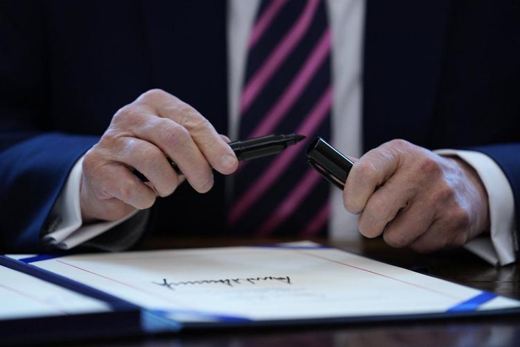 Trump's signature, a symbol of presidential power, is under new ...