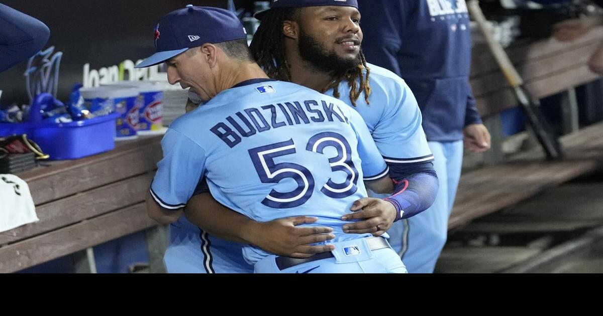 Blue Jays coach Mark Budzinski and SS Paul DeJong