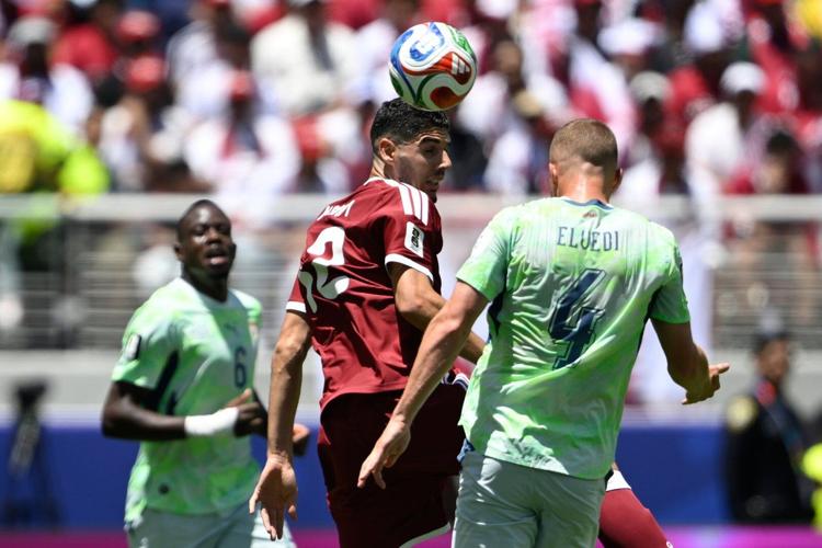 Boualem Khoukhi's goal on header in stoppage time earns Qatar a 1-1 ...