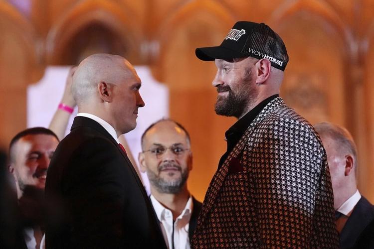 Usyk dresses as a hitman and gets Fury's signature in bizarre news ...
