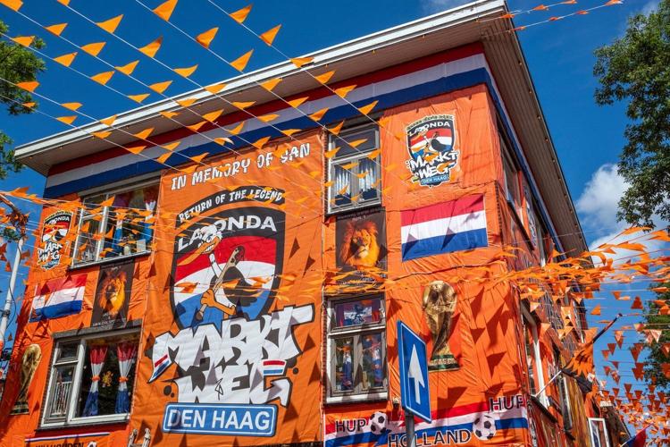 A street in The Hague is drenched in orange as Netherlands soccer fans ...