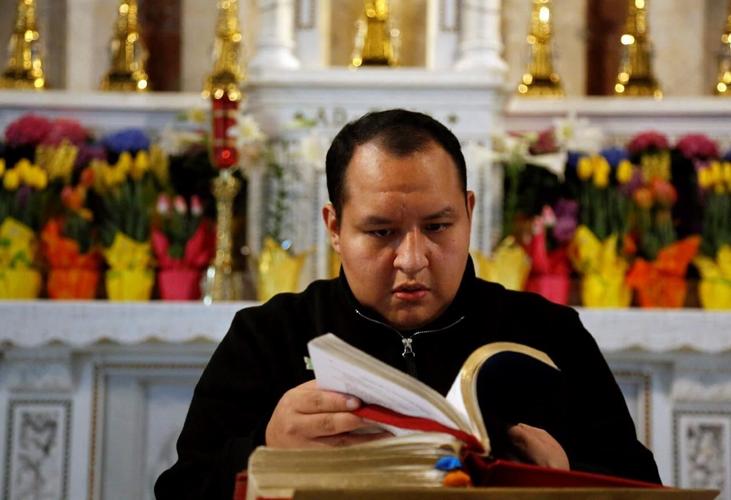 Young priest loses mentor, then his father -- both to virus