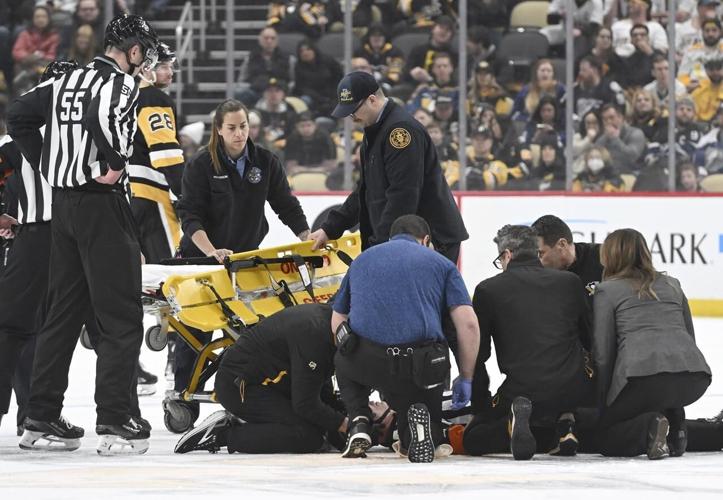 Referee Steve Kozari taken off ice on stretcher after collision with ...
