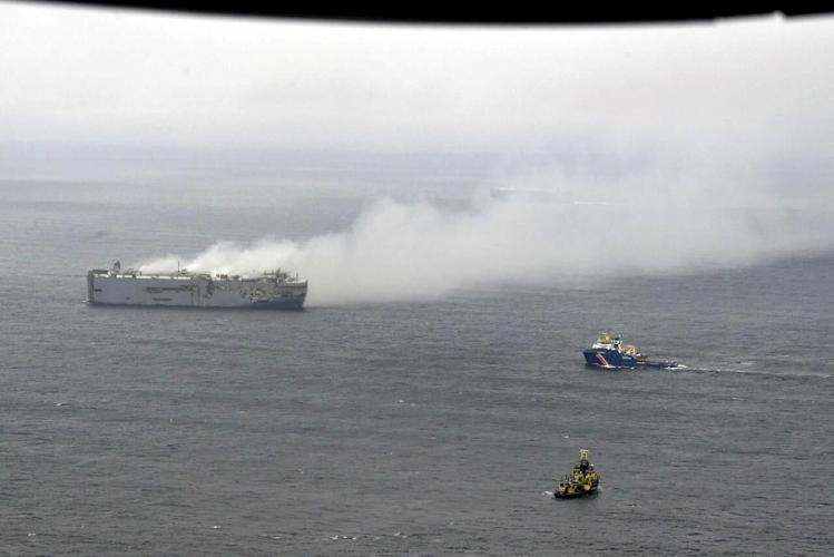 Salvage crews wait for chance to board a freighter burning for two days ...