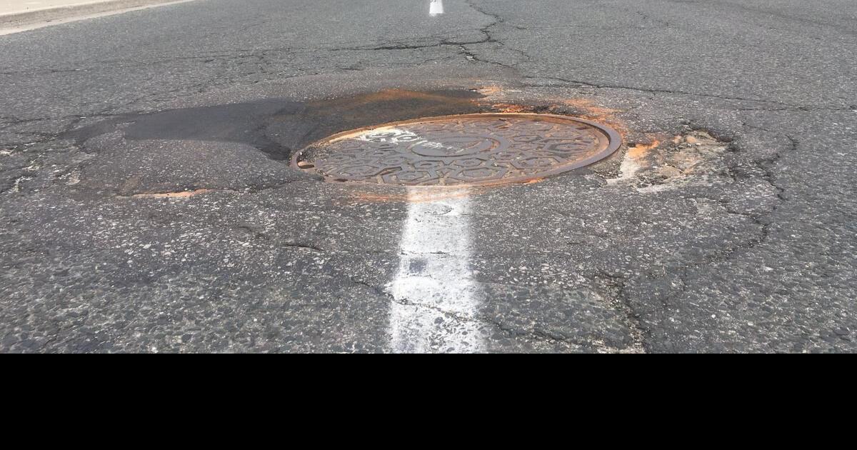 Sunken utility chamber lid rattles Kingston Rd. drivers