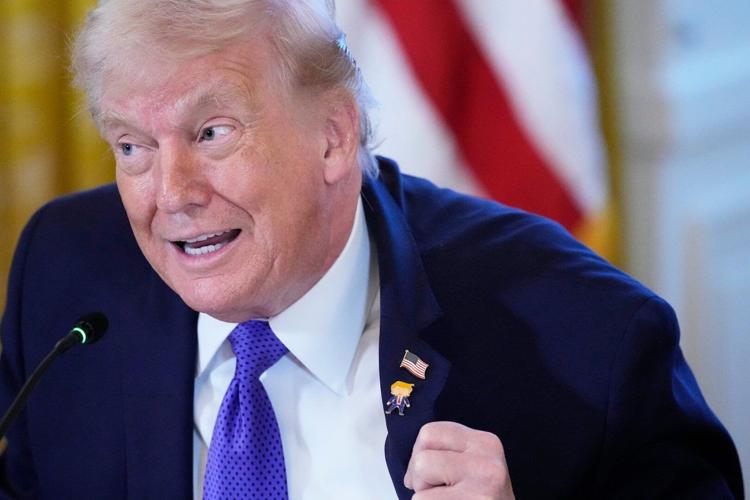 Trump wears a new 'Happy Trump' lapel pin, but insists he's never happy