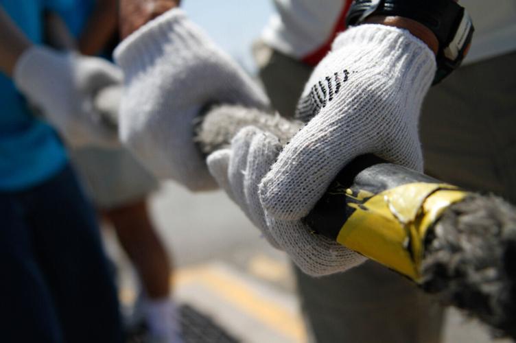 Plane-pulling teams flex muscles for charity