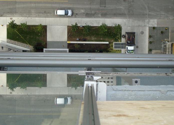 Shattered glass rains down from condo tower