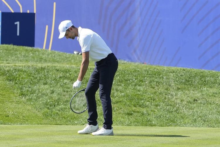 Novak Djokovic takes his tennis racket onto the first tee of golf's ...