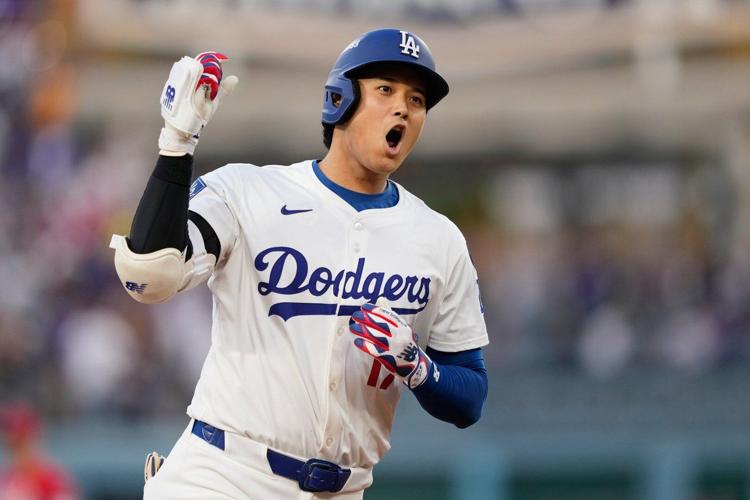Ohtani hits 2 homers for Dodgers in playoff opener against Reds