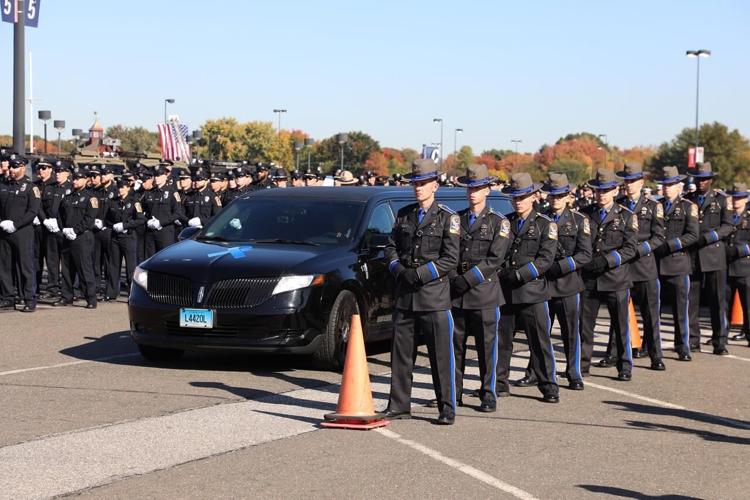 Funeral for 2 ambushed officers draws peers from around US