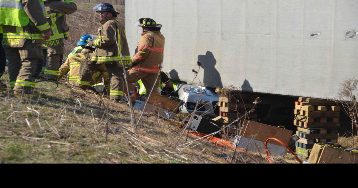 Woman trapped under tractor-trailer comes out smiling and unharmed