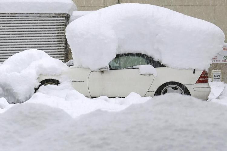 Snow piles deep in northern Japan, strands vehicles, 3 dead