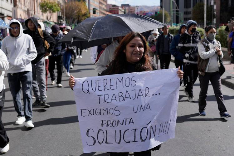 Protesters, police clash in Bolivia after president signs law enabling ...