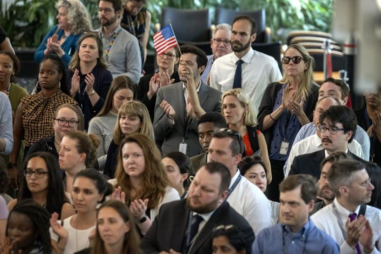 Photos of US State Department workers getting hugs and applause as they ...
