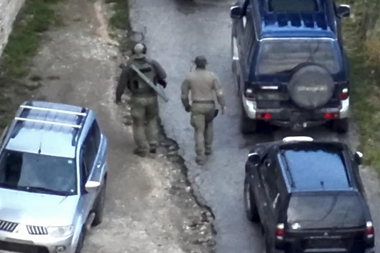 Kosovar police surround a village after Serb gunmen storm a monastery ...