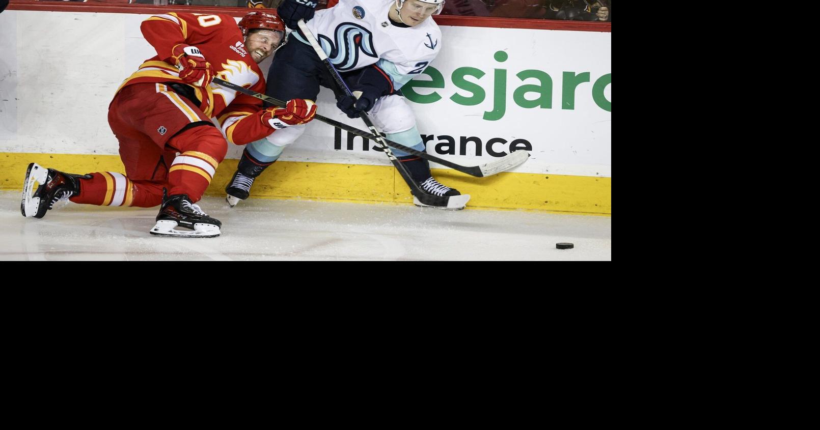 Surging Kraken score four times in third period to burn Flames 5-1