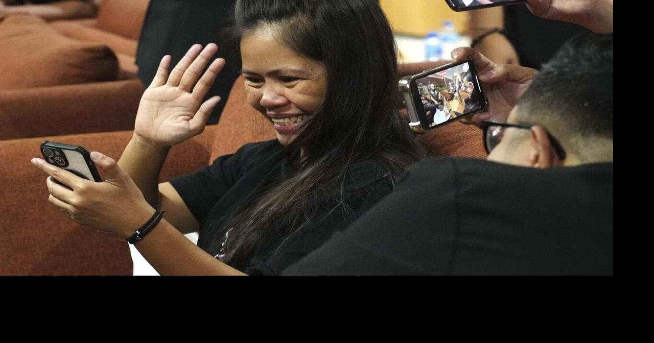 Filipina who won a last-minute reprieve from an Indonesian firing squad returns home