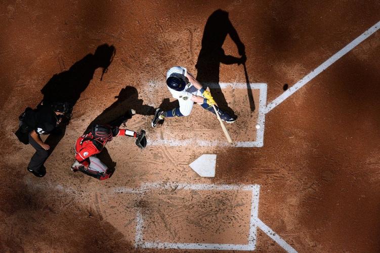 Reds lose 4-2 to the Brewers but end up in playoffs anyway after Mets fall