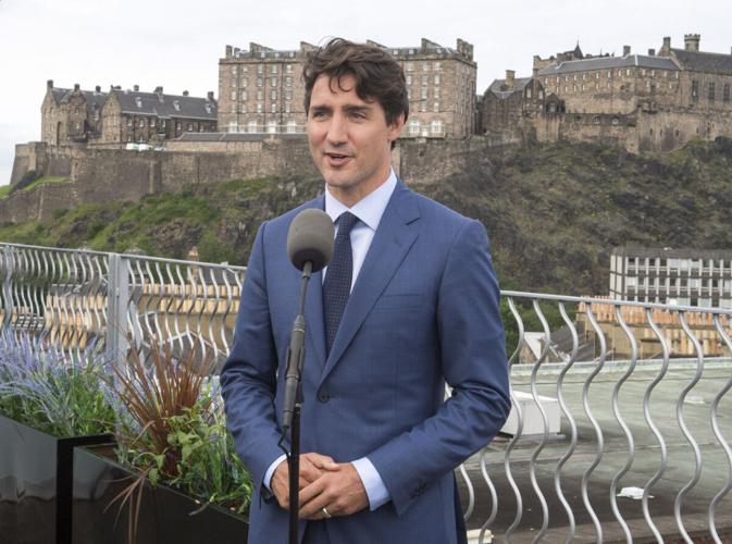 Trudeau gives the Queen flag that flew on Parliament Hill on Canada Day