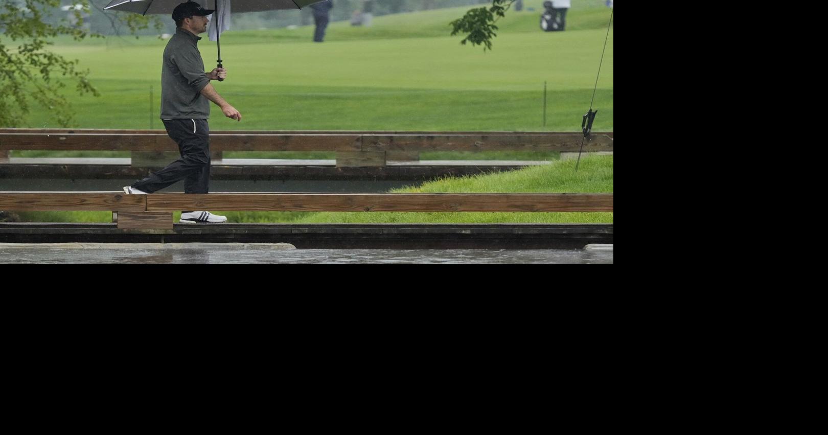Canada's Nick Taylor makes it look easy in the rain and shares the lead ...
