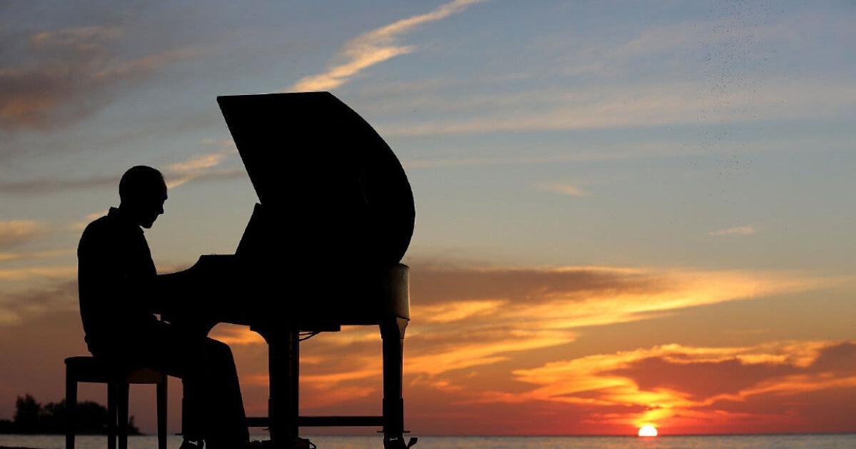Solar piano man takes to the Beach at sunrise