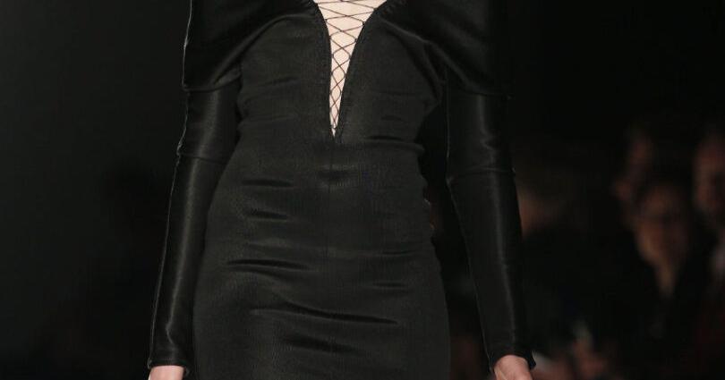 Style with a sneer: Models stalk down runway looking surly
