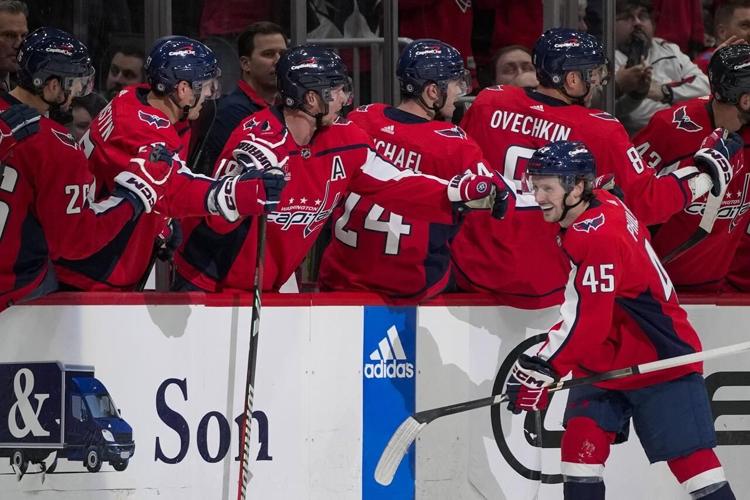 Phillips scores against old team, Capitals beat Flames 3-2 in shootout