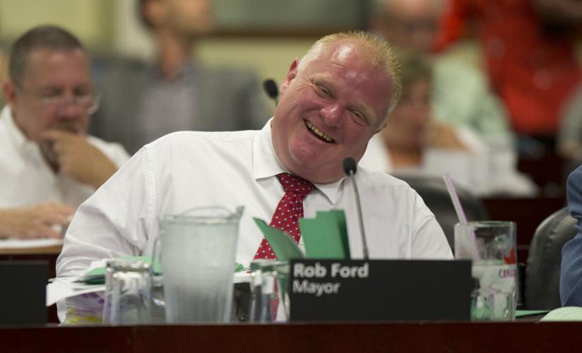 Rob Ford, from behind new city hall safety barrier, ignores media questions