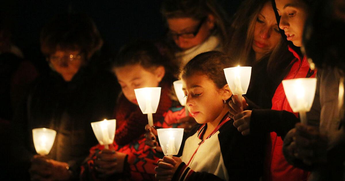 Hundreds gather in vigil to remember Neville-Lake family