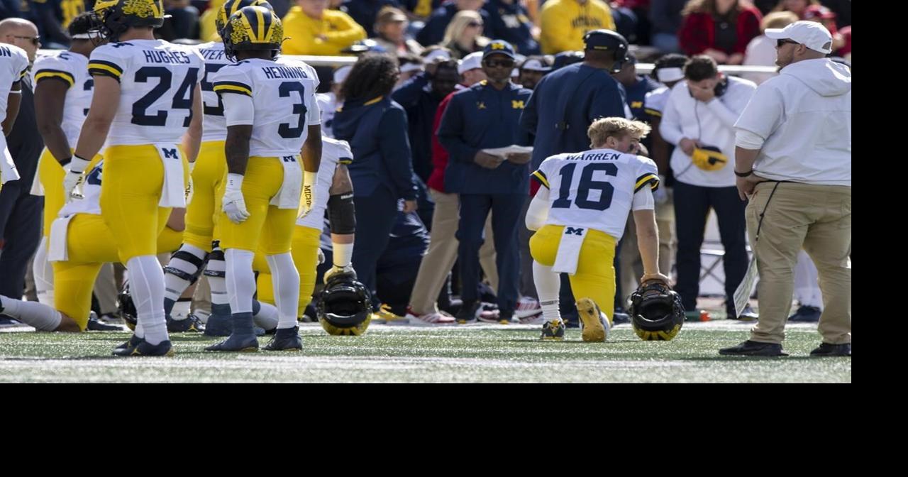 Michigan assistant coach Hart carted off field on backboard