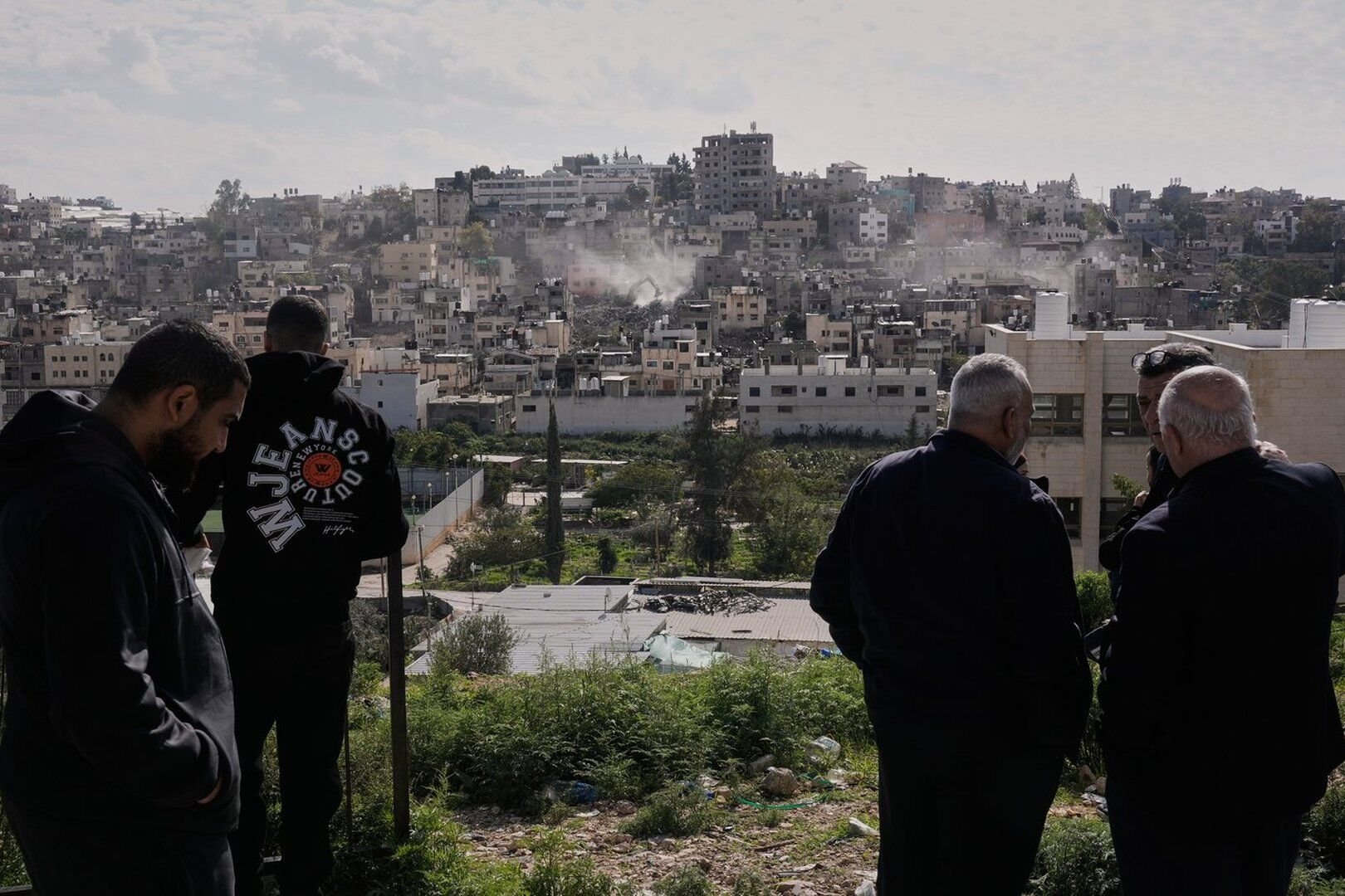 Palestinians watch as Israeli bulldozers claw down their West Bank homes