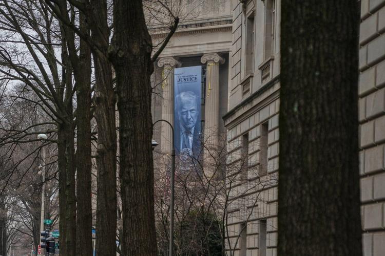 Large banner featuring Trump's face is displayed on Justice Department ...