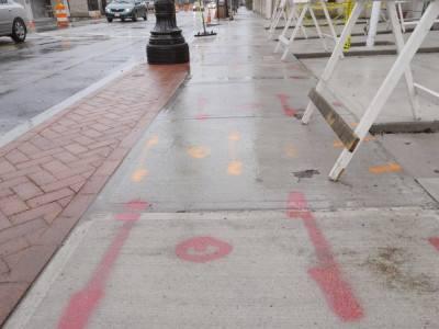 Freshly poured city sidewalk stained by utilities' spray paint | Local ...