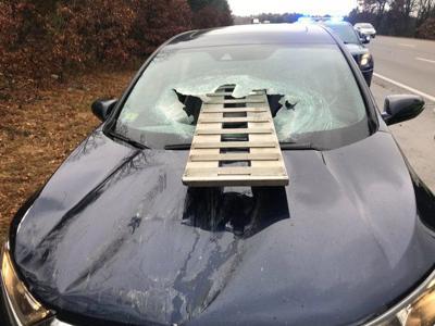 Woman narrowly escapes injury after truck loading ramp crashes through ...
